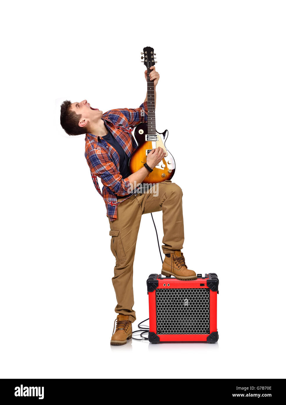 expressive rocker man playing an electric guitar with combo amp Stock ...