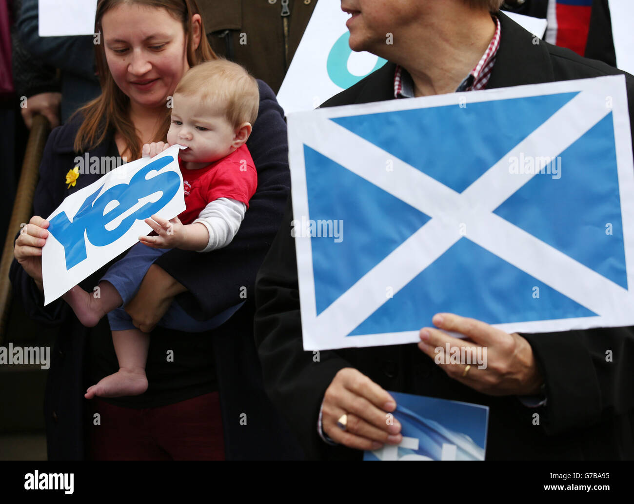 Six month old Caitlin Tierney with mum Emma Connell chews a YES banner ...