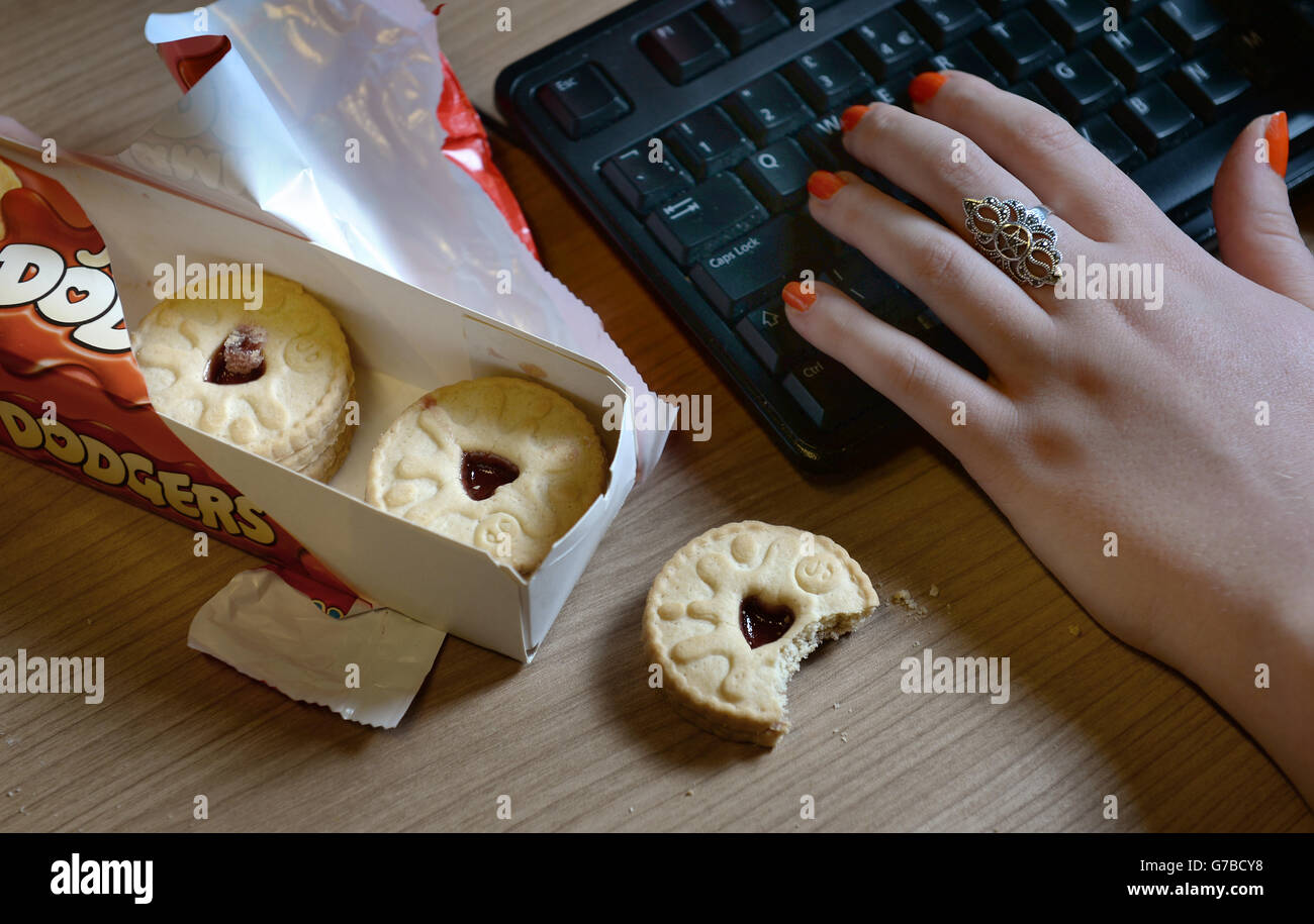 An office workers eats jammy dodger biscuit desk hi-res stock ...