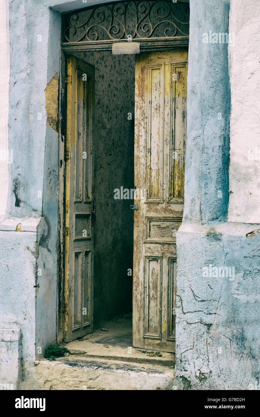 Photograph of an old wood open door and old building Stock Photo - Alamy