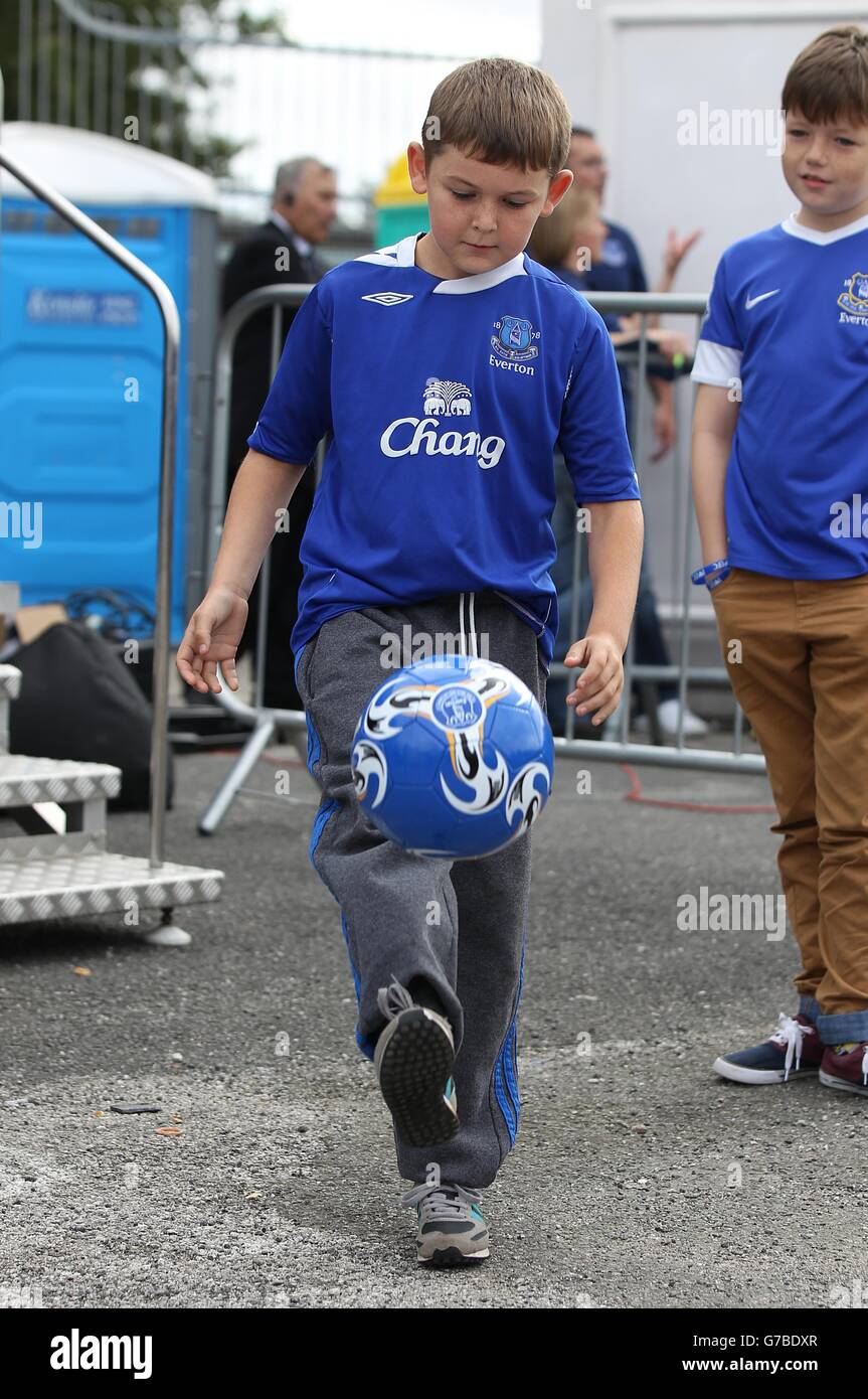 A young fan does keepy uppies in the Everton fan zone before the match ...
