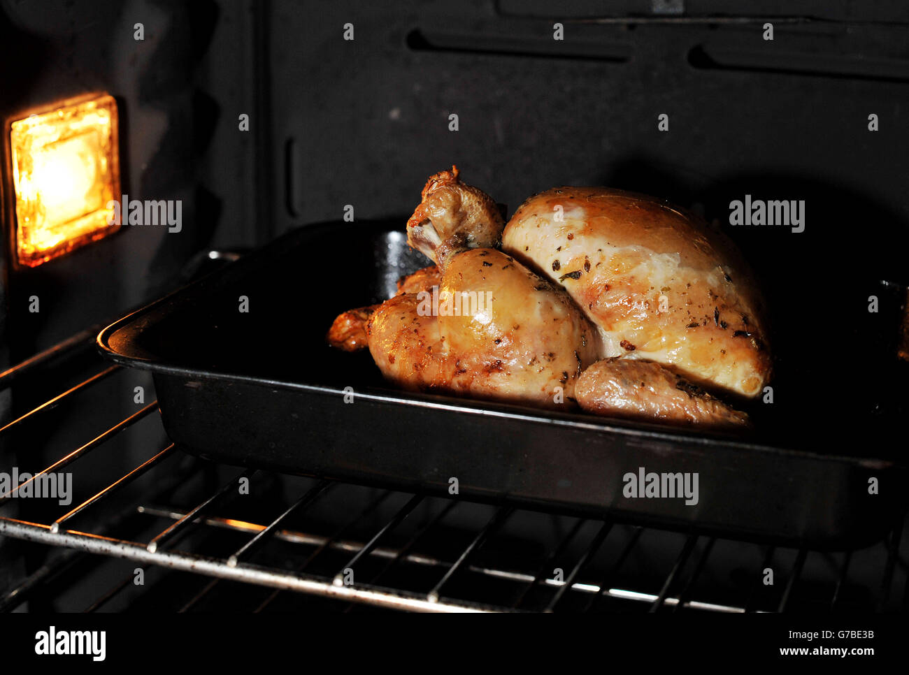 A chicken being roasted in a household oven, as poor food hygiene ...