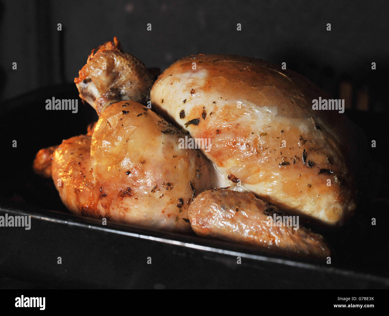 A chicken being roasted in a household oven, as poor food hygiene ...