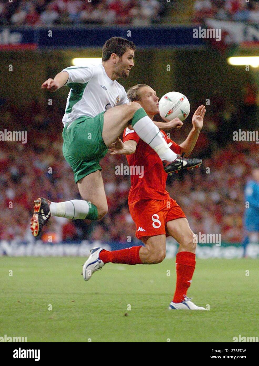 Wales' Craig Bellamy (right) is intercepted by Jeff Whitley of Northern ...