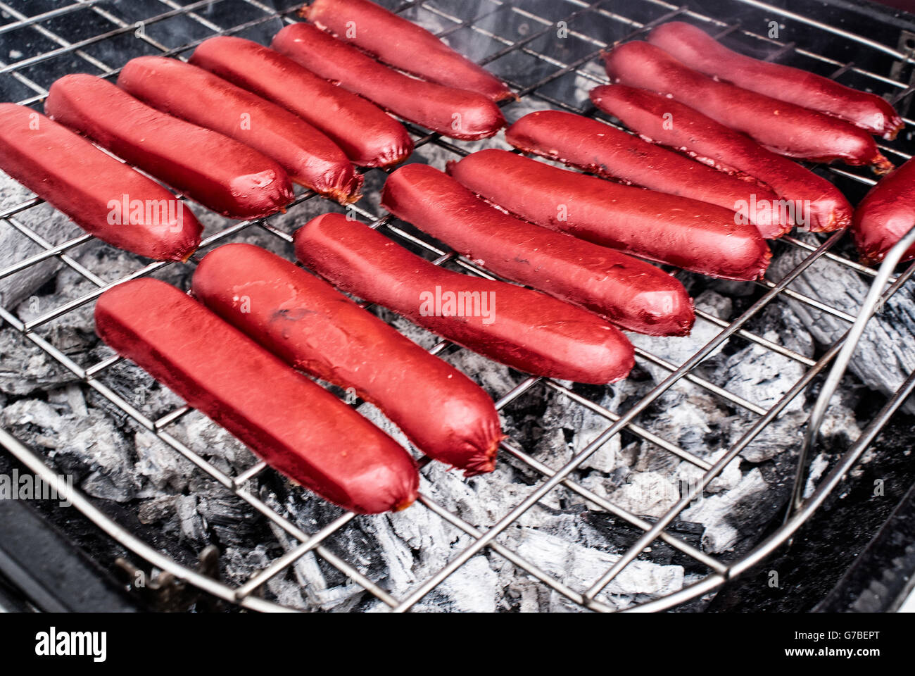 Photograph of some red pork sausages at a hot grill Stock Photo - Alamy