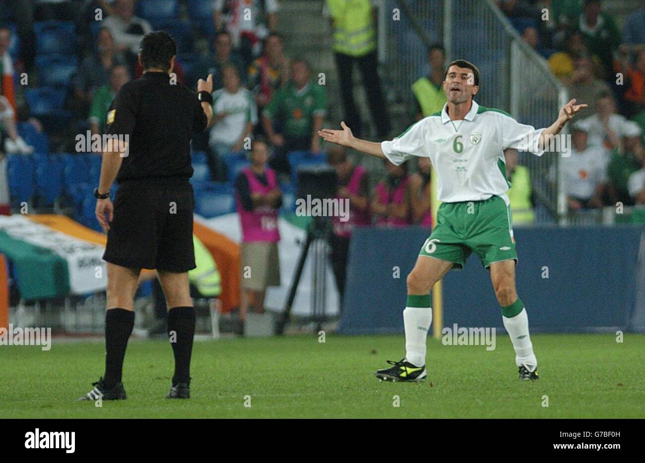 Ireland player, Roy Keane disputes one of match referee Andrejs Sipailo ...