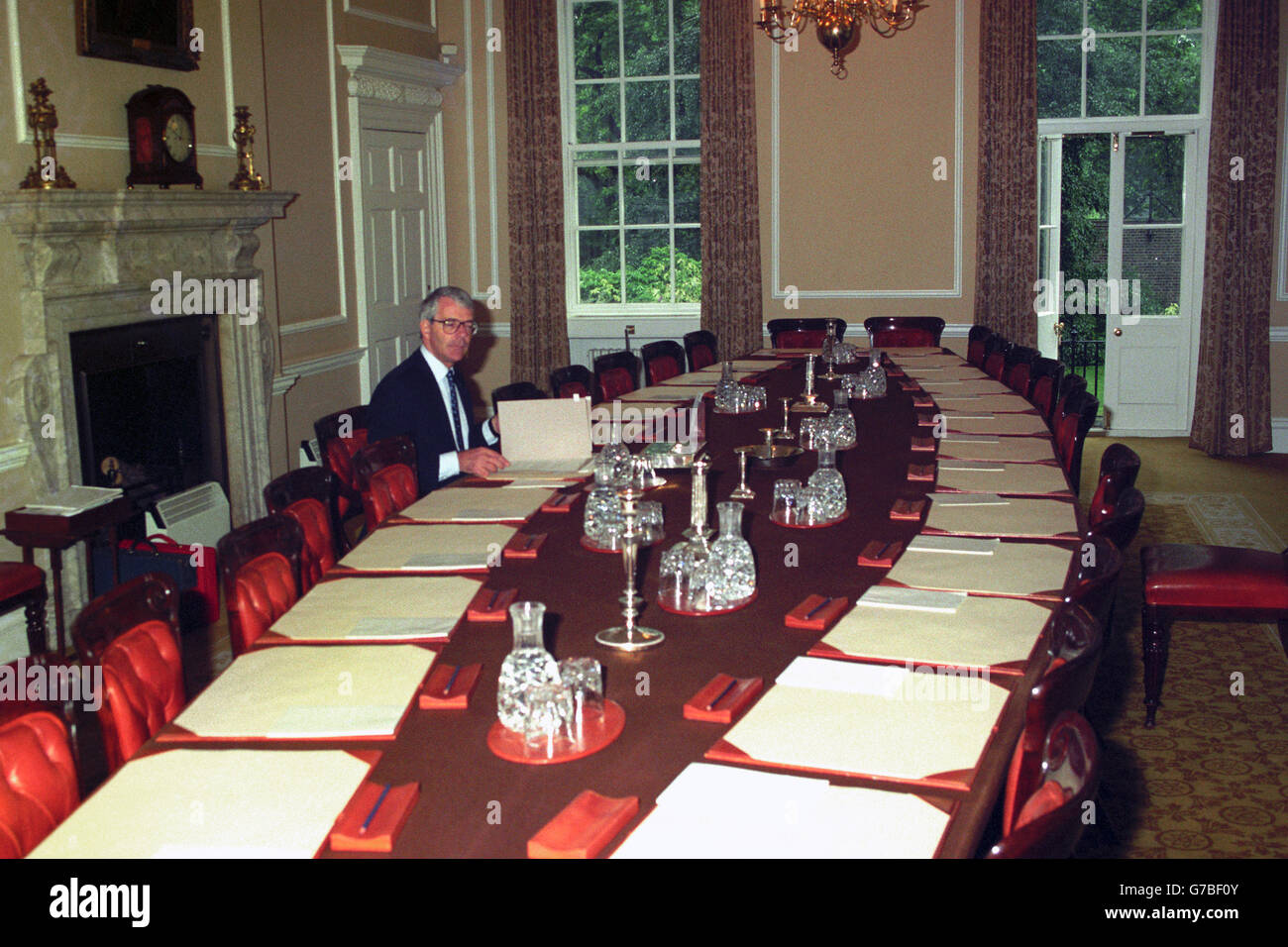 Prime Minister John Major sits alone as he prepares for a Cabinet ...