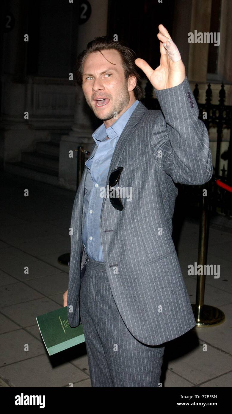 Actor Christian Slater, appears to have a broken finger as he arrives ...