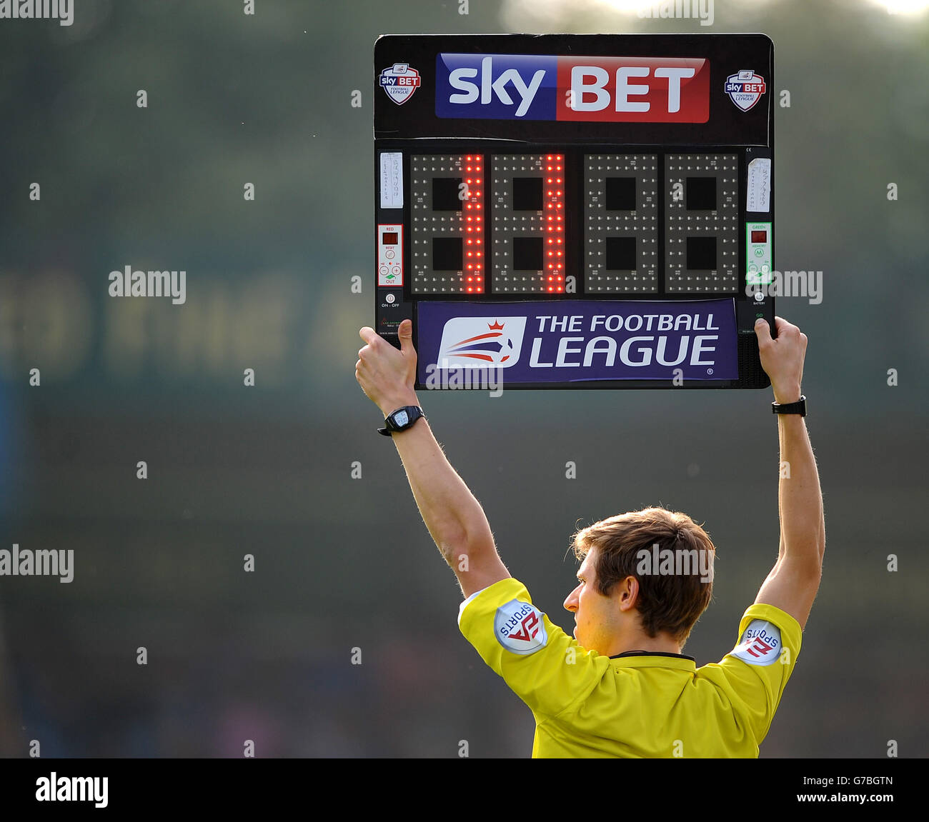 The assistant referee holds up the board to indicate eleven minutes of ...