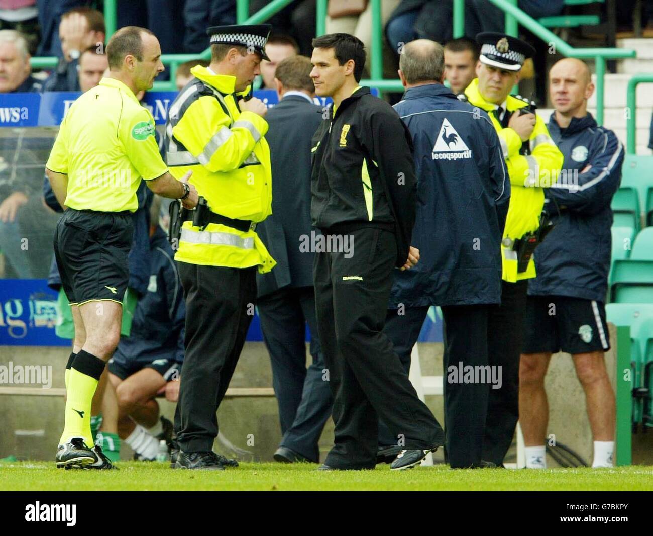 Referee Michael McCurry talks to the 4th official Craig Thomson about a ...