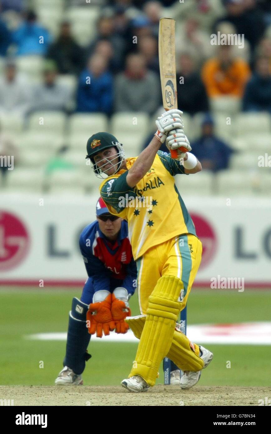 Australia's Damien Martyn drives a delivery from England's Ashley Giles ...