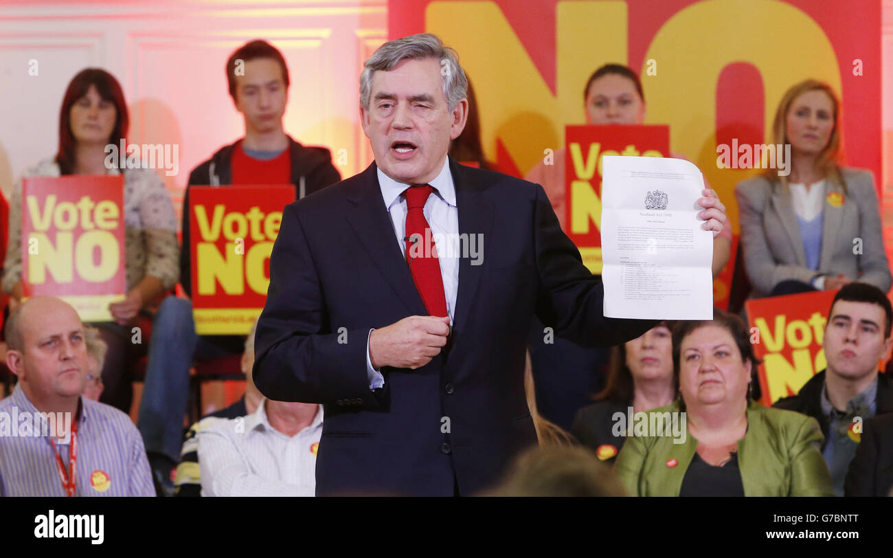 Former Prime Minister Gordon Brown holds a page from the Scotland Act ...