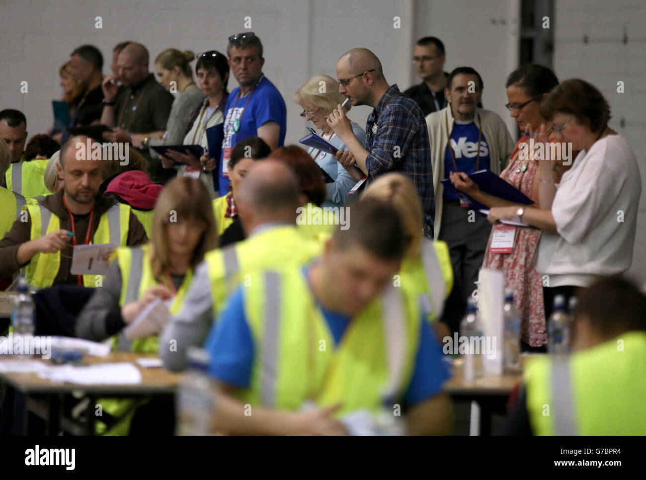 Counting agents watch as ballot papers are counted in the Highland Hall ...