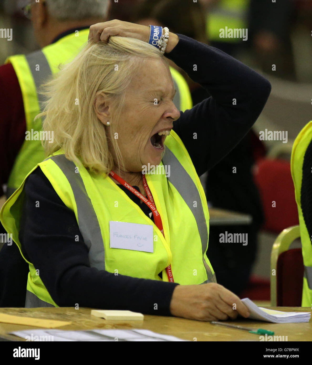 Counting staff yawn as they count ballot papers through the night at ...