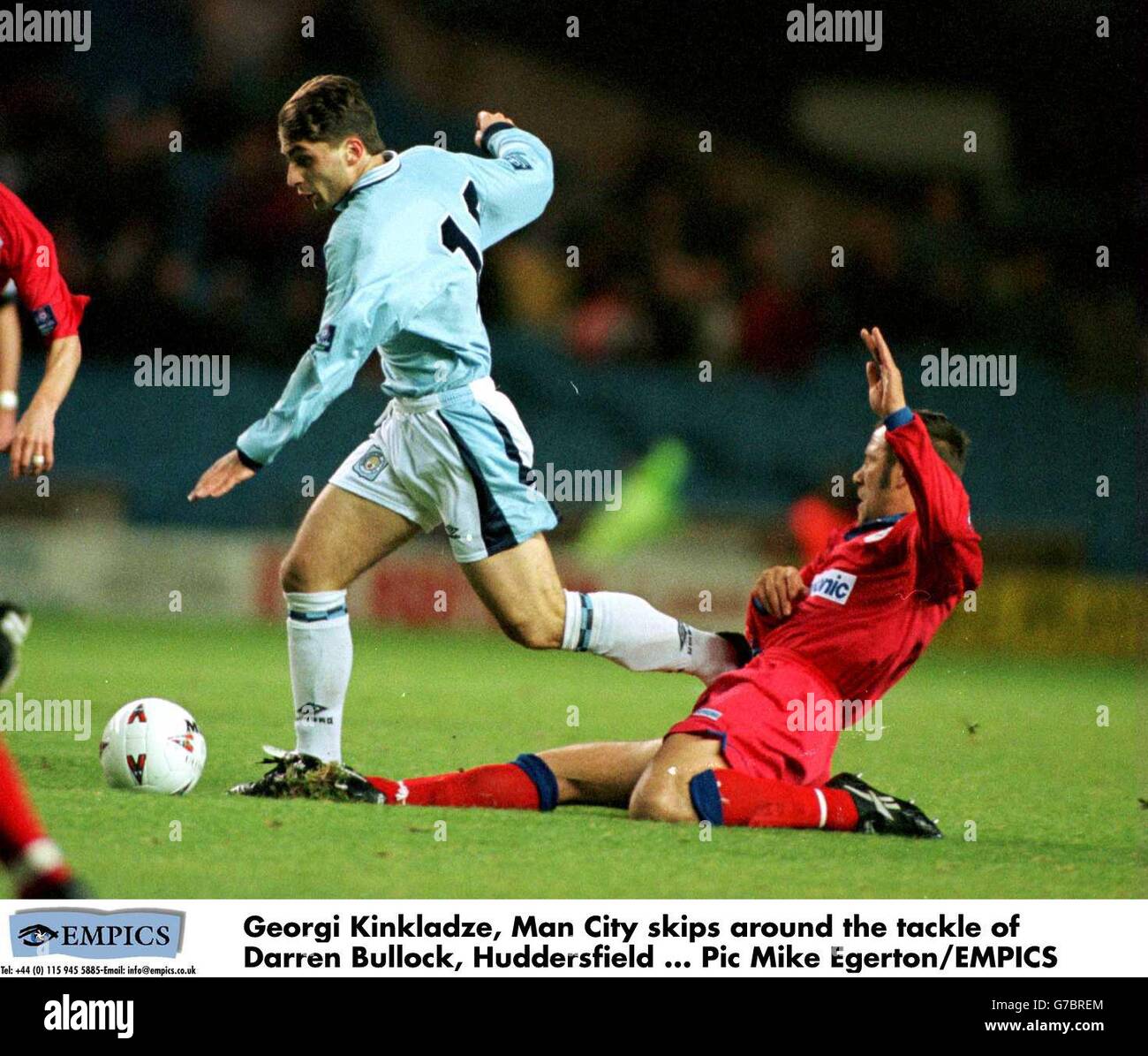 Georgi Kinkladze, Man City skips around the tackle of Darren Bullock ...
