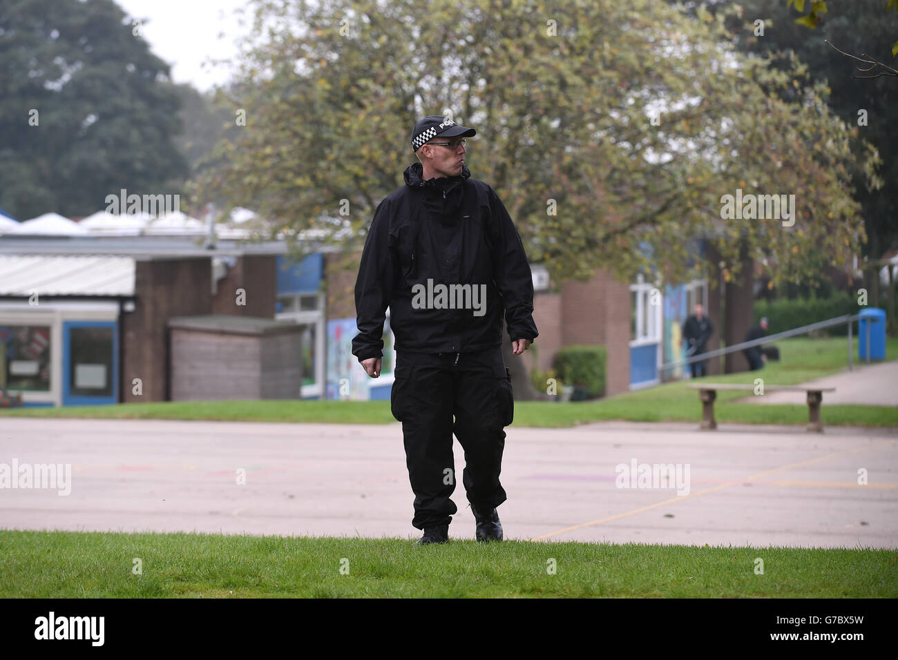 A police officer patrols the grounds of Mount Pleasant Primary School ...