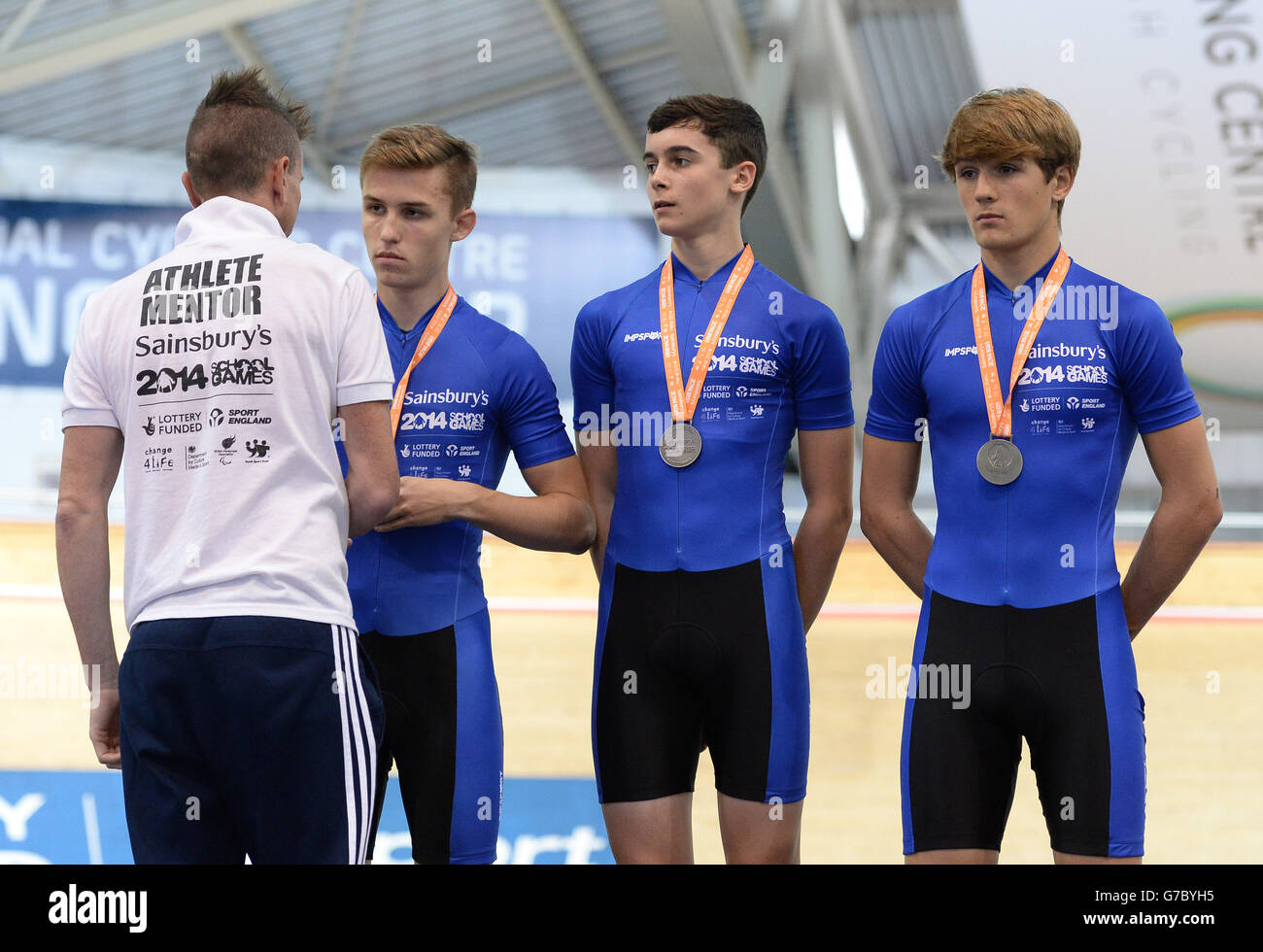 Athlete mentor and paralympian Rik Waddon presents medals during the ...