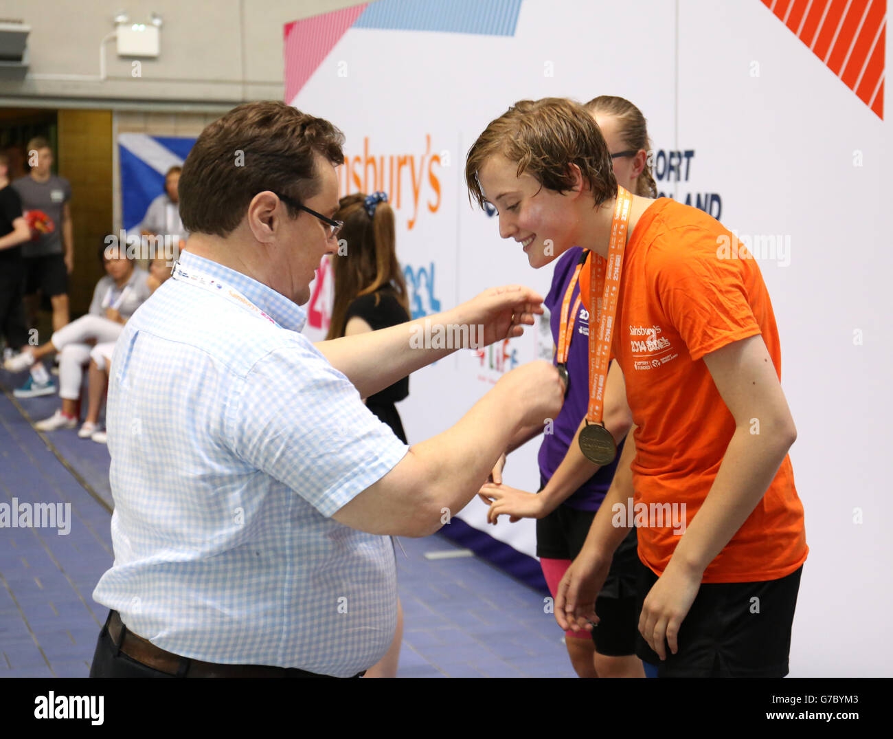 The Chairman of British Swimming David Sparkes awards a gold medal to ...