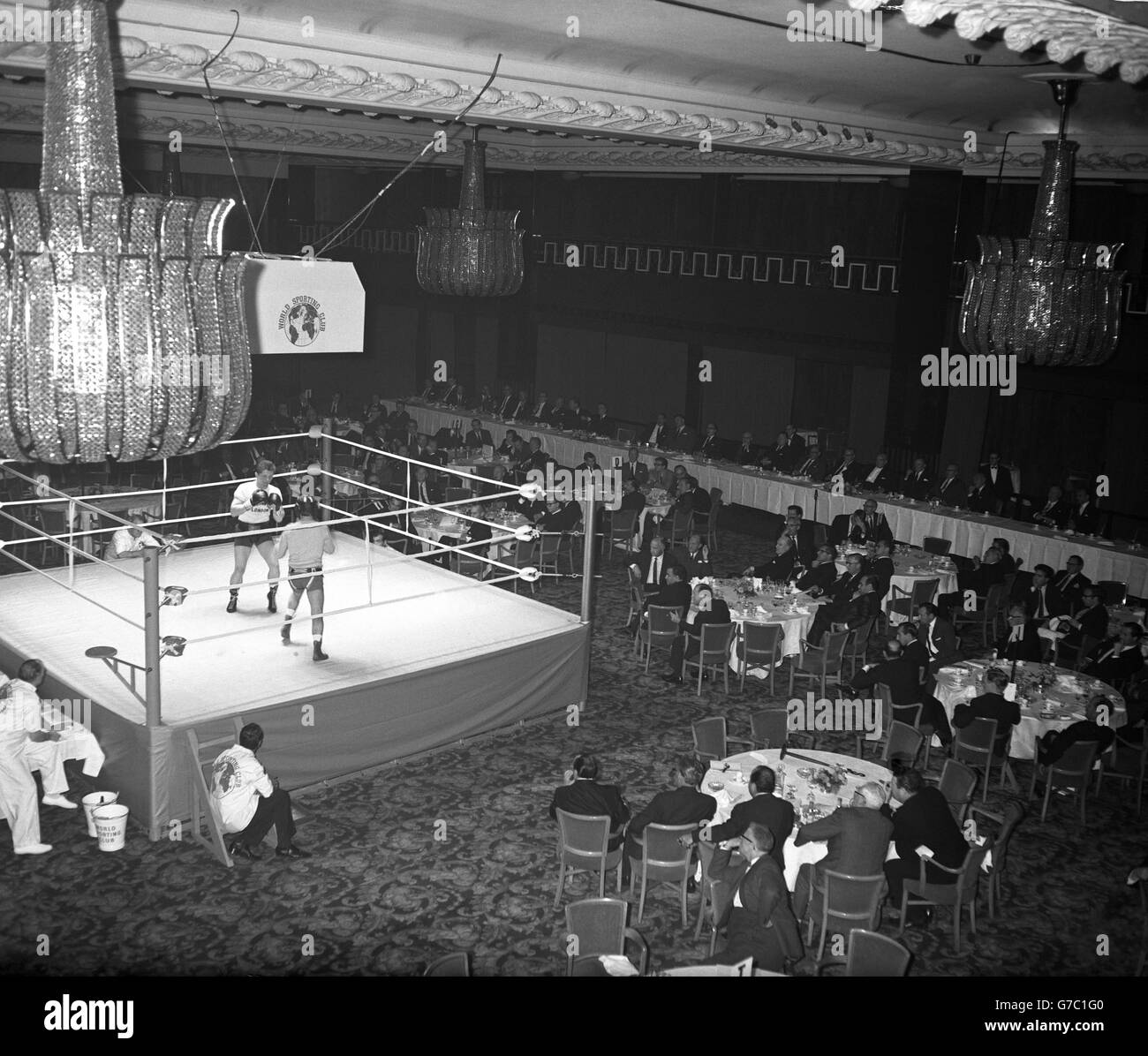 Guests at the luncheon watch a sparring match between Walter McGowan ...