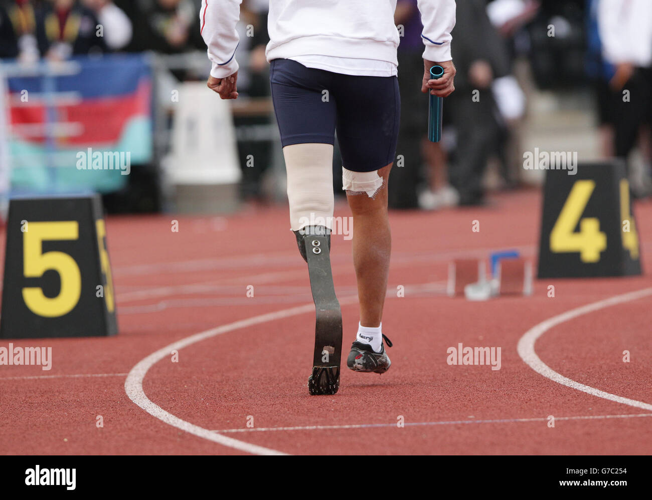 A competitor wearing a prosthetic running blade before the start of the ...