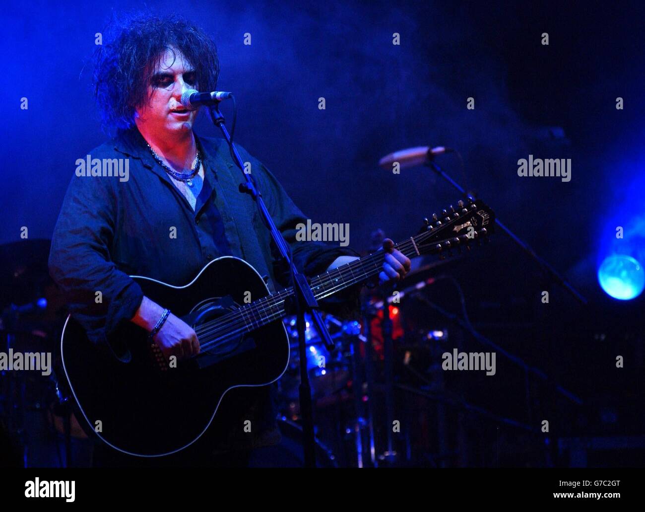 Robert Smith, lead singer of The Cure, performing on stage as part of ...
