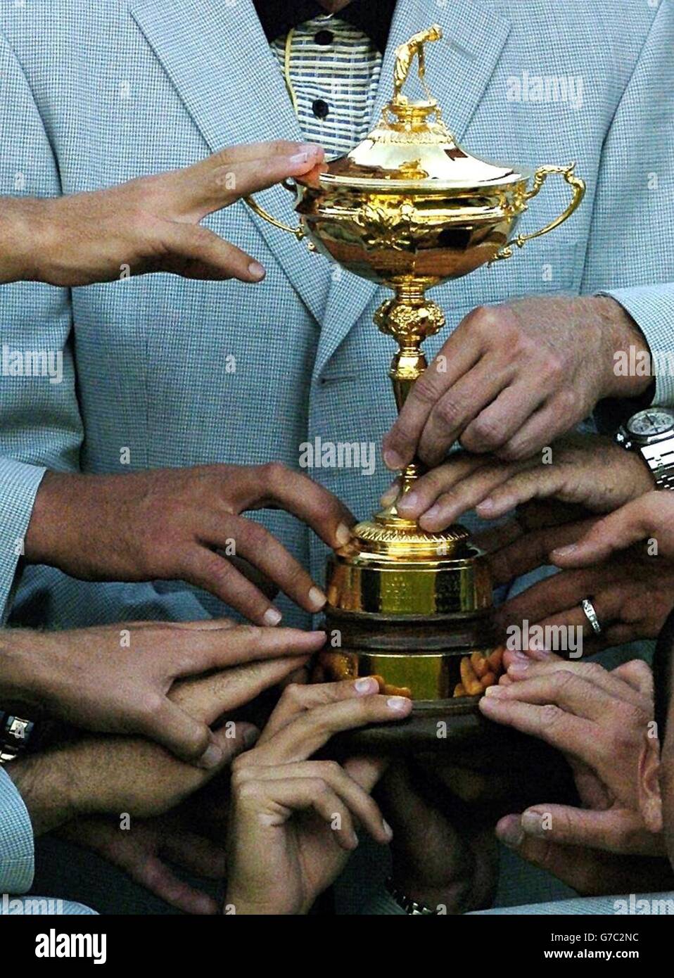 The European Ryder Cup team with their hands back on the trophy after ...