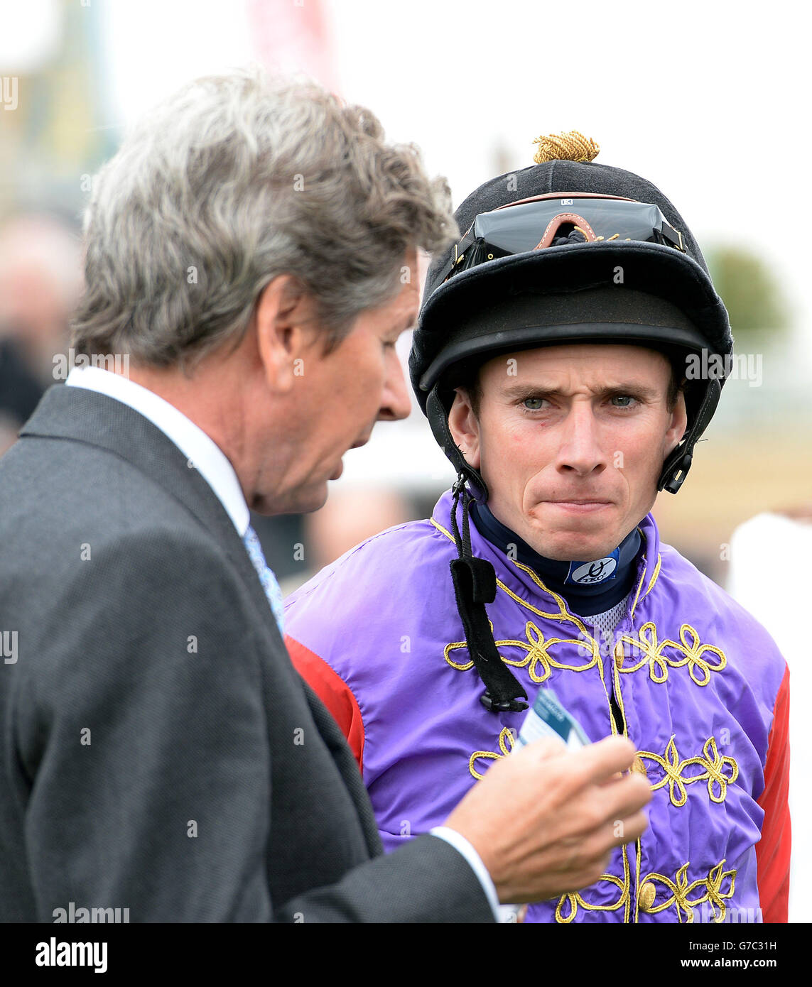 Jockey Ryan Moore talks to John Warren, the Queen's racing adviser ...