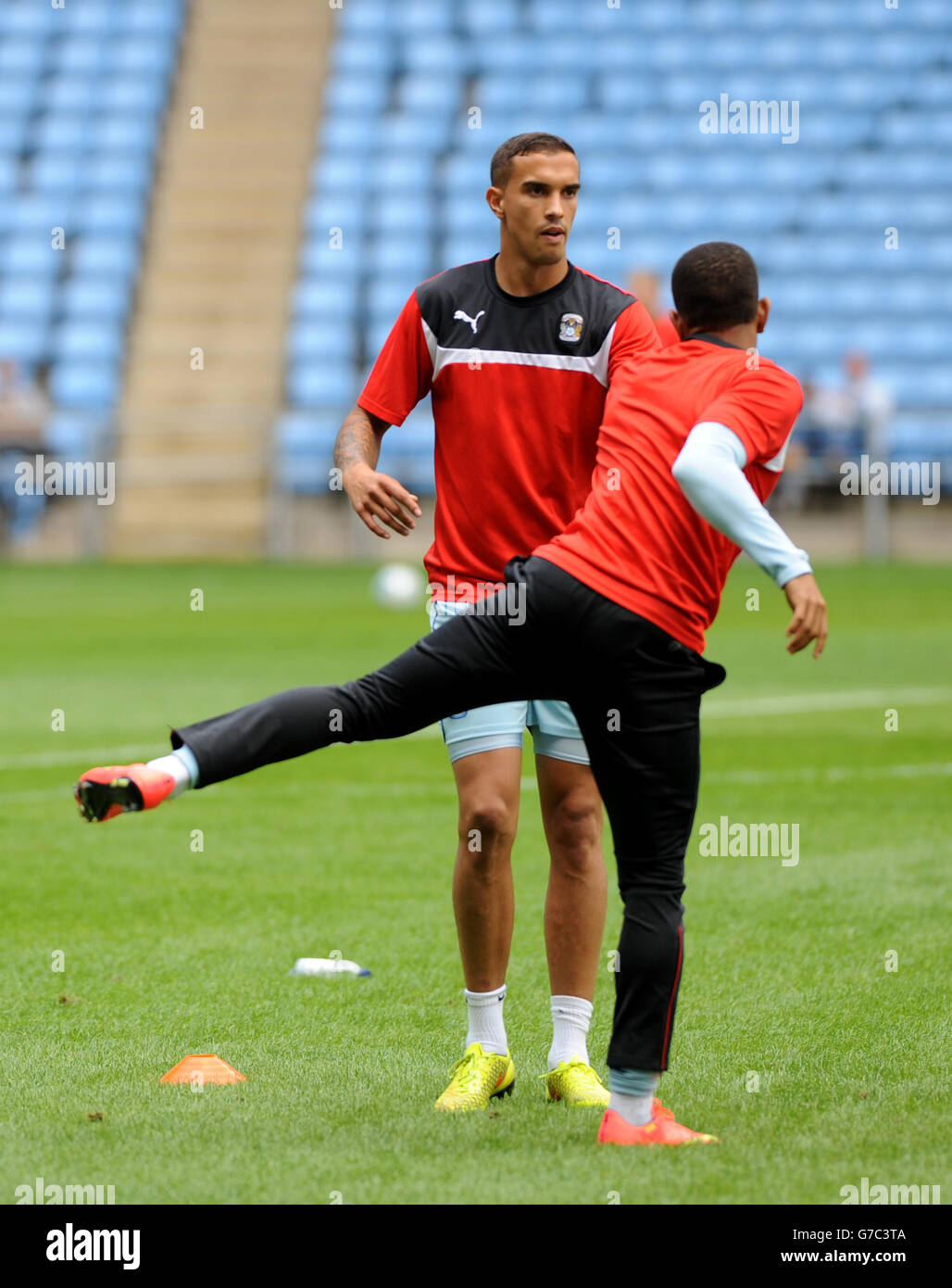 Coventry City's Seb Hines (left) stretches during the warm up Stock ...