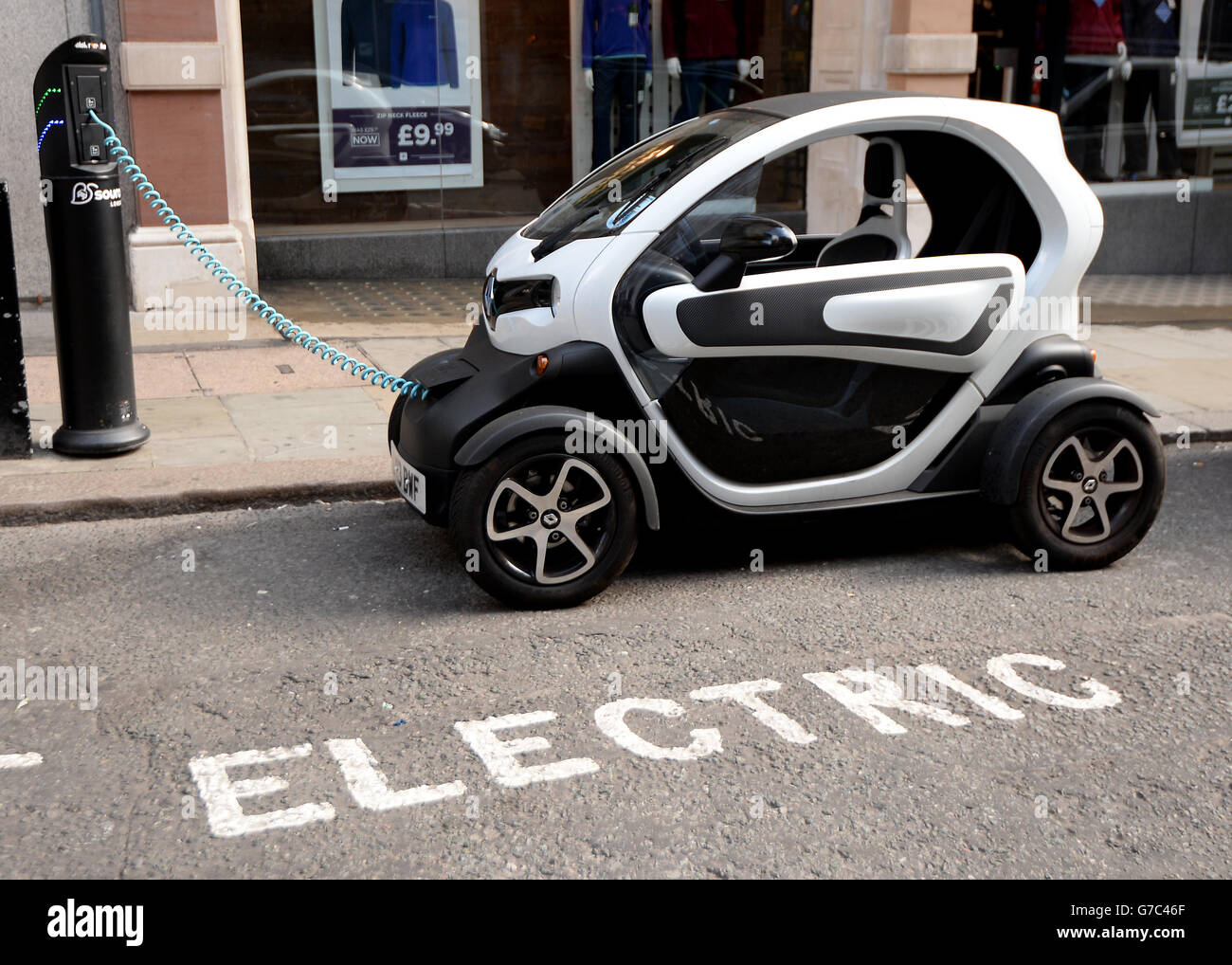 A Renault Twizy, an electric car, is charged form an electric car ...