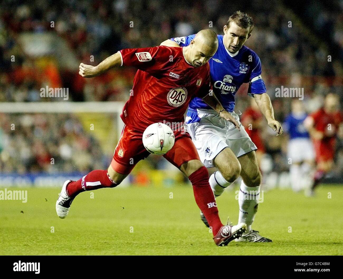 Bristol City's Christian Roberts (left) holds off the challenge of ...