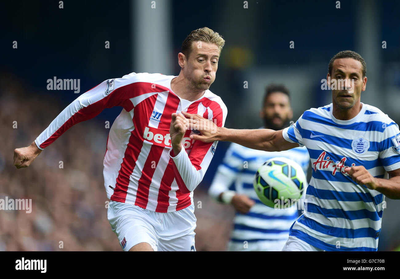 Stoke City's Peter Crouch (left) and Queens Park Rangers' Rio Ferdinand ...