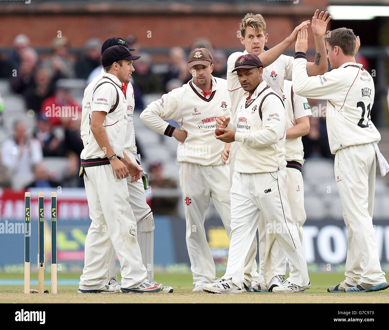 Lancashire's Tom Bailey (centre) celebrates taking the wicket of ...