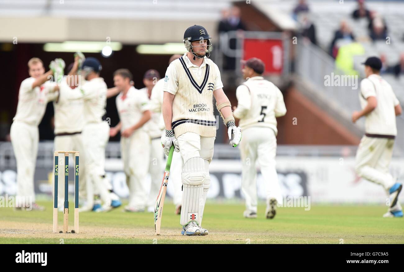 Middlesex batsman Sam Robson leaves the pitch after being caught out by ...