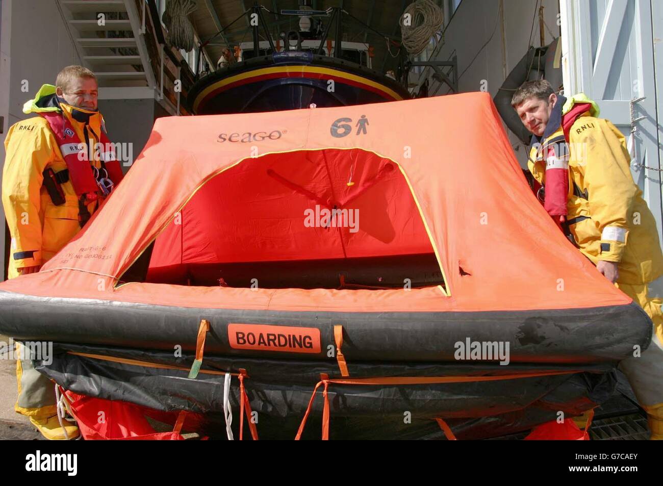 Padstow lifeboat crewmen Steve Conium and Mike Smith manhandle the ...