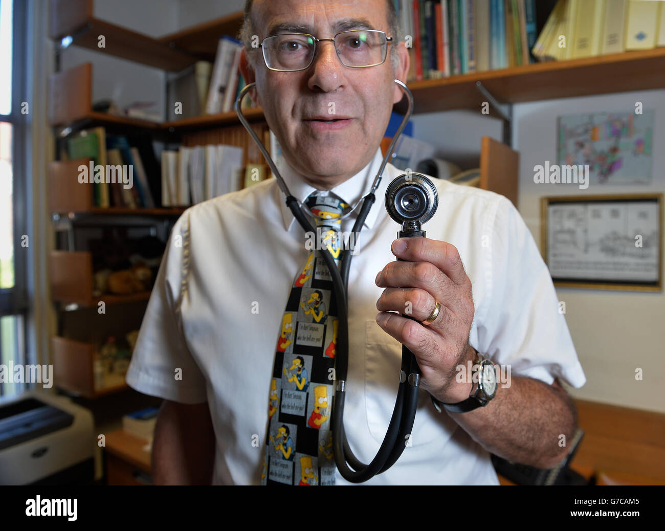 Dr Laurence Buckman poses with a stethoscope in his practice room at ...