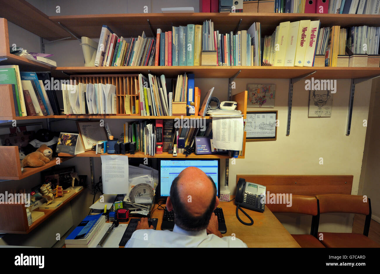 Dr Laurence Buckman works at a computer in his practice room at the ...