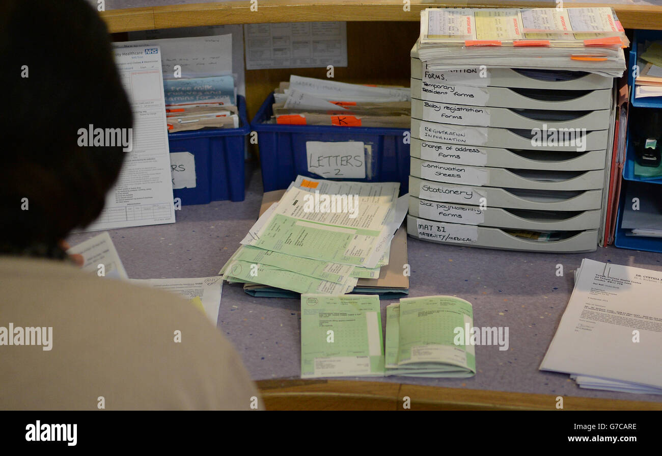 A receptionist sorts prescriptions at the Temple Fortune Health Centre ...