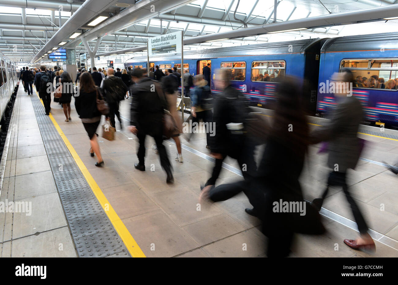 Commuter Stock. Commuters make their way across a platform at ...