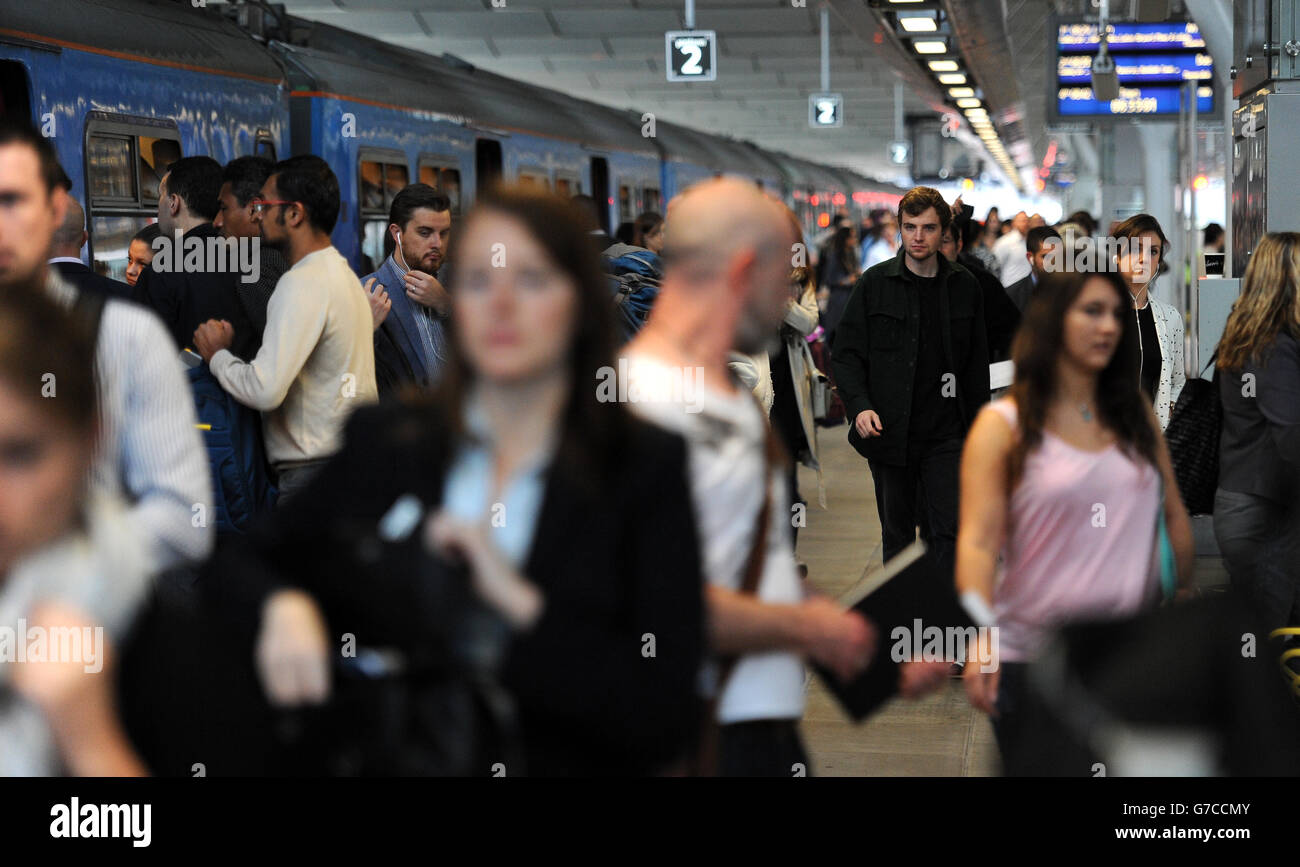 Commuter Stock. Commuters make their way across a platform at ...