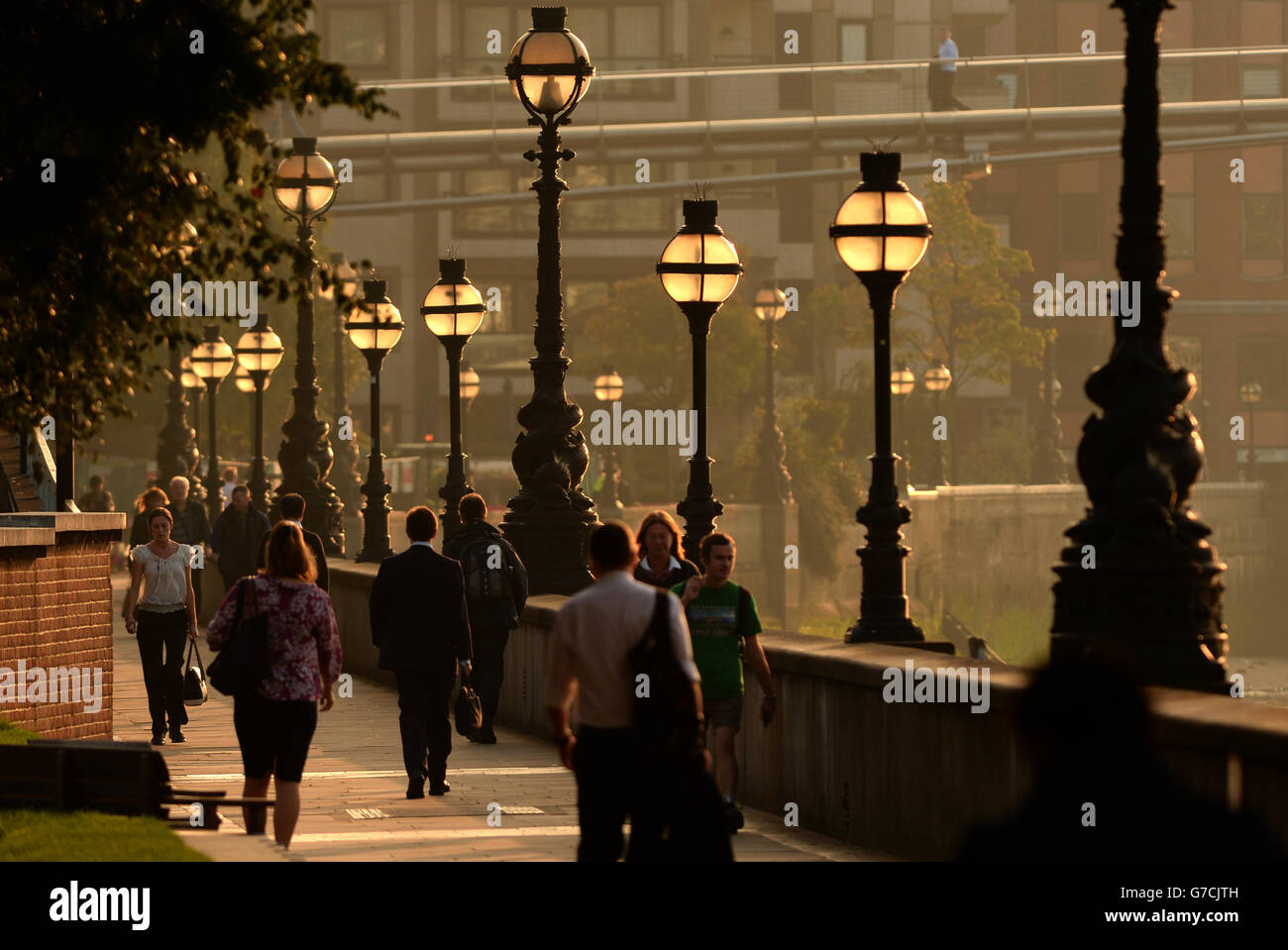 Commuters walk along the Embankment at sunrise in London Stock Photo ...
