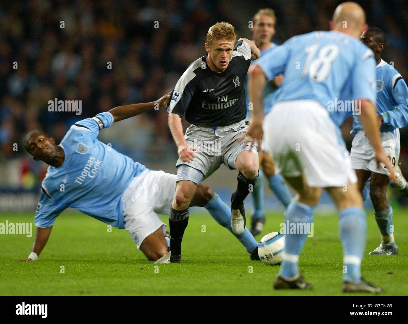 Chelsea's Damien Duff skips a challenge from Manchester City's Sylvain ...