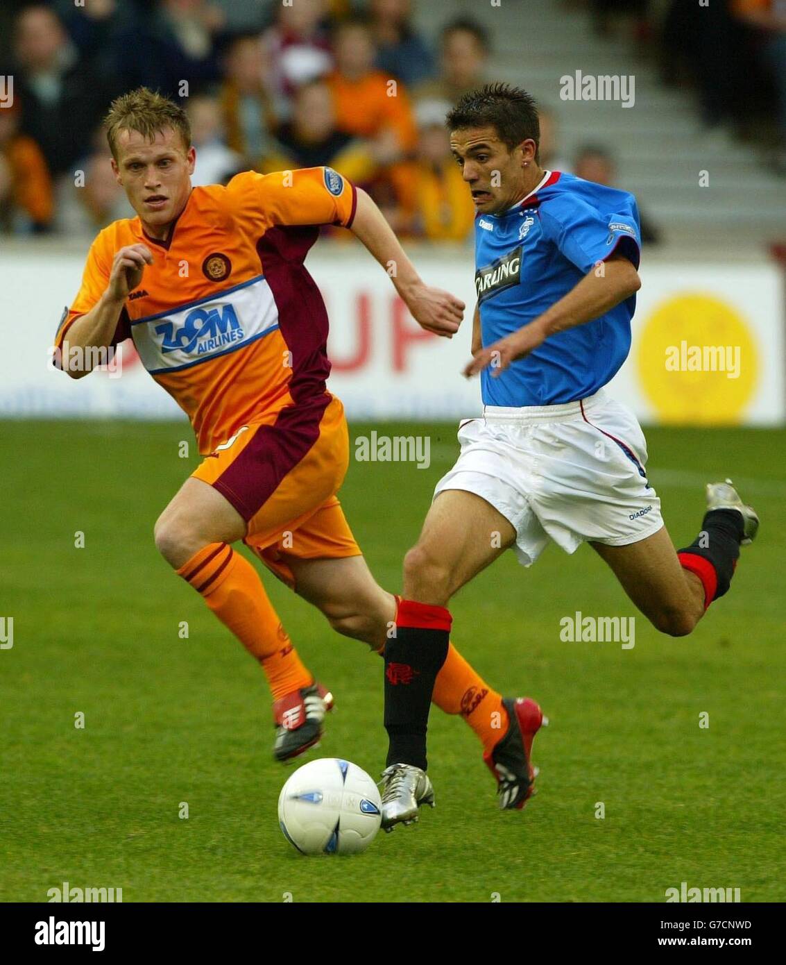 Nacho Novo of Rangers runs from Motherwell's Steven Hammell during the ...