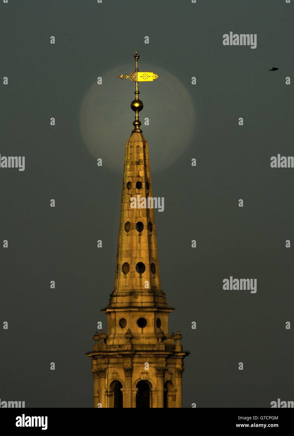 The October full moon sets behind the steeple of St Martin-in-the ...