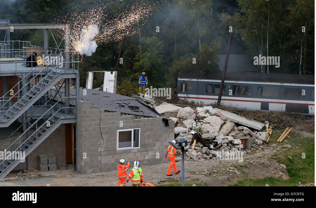 Rescue workers attend to a train carriage during a staged railway ...