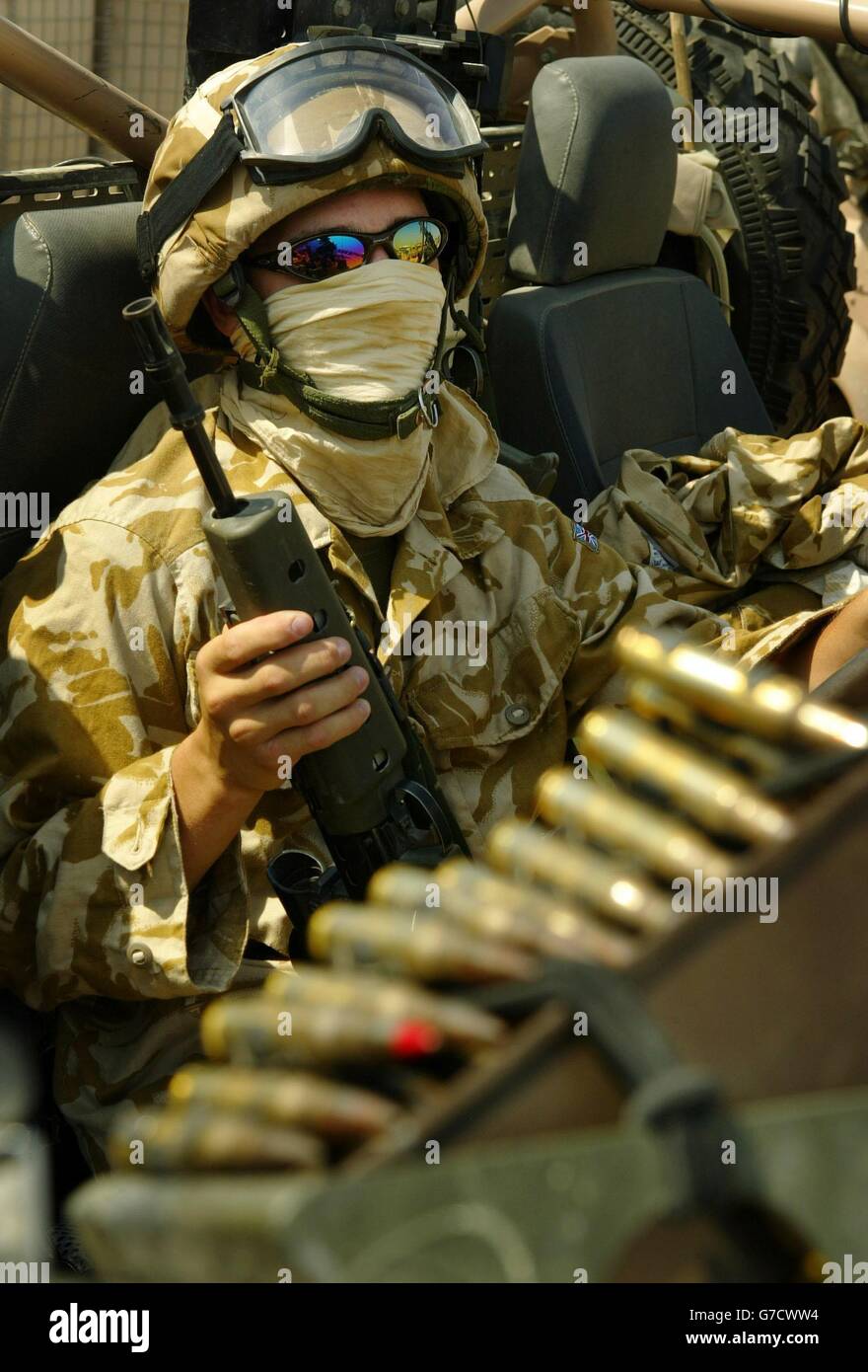 A soldier from 51 Squadron RAF Regiment covers his mouth and nose from ...