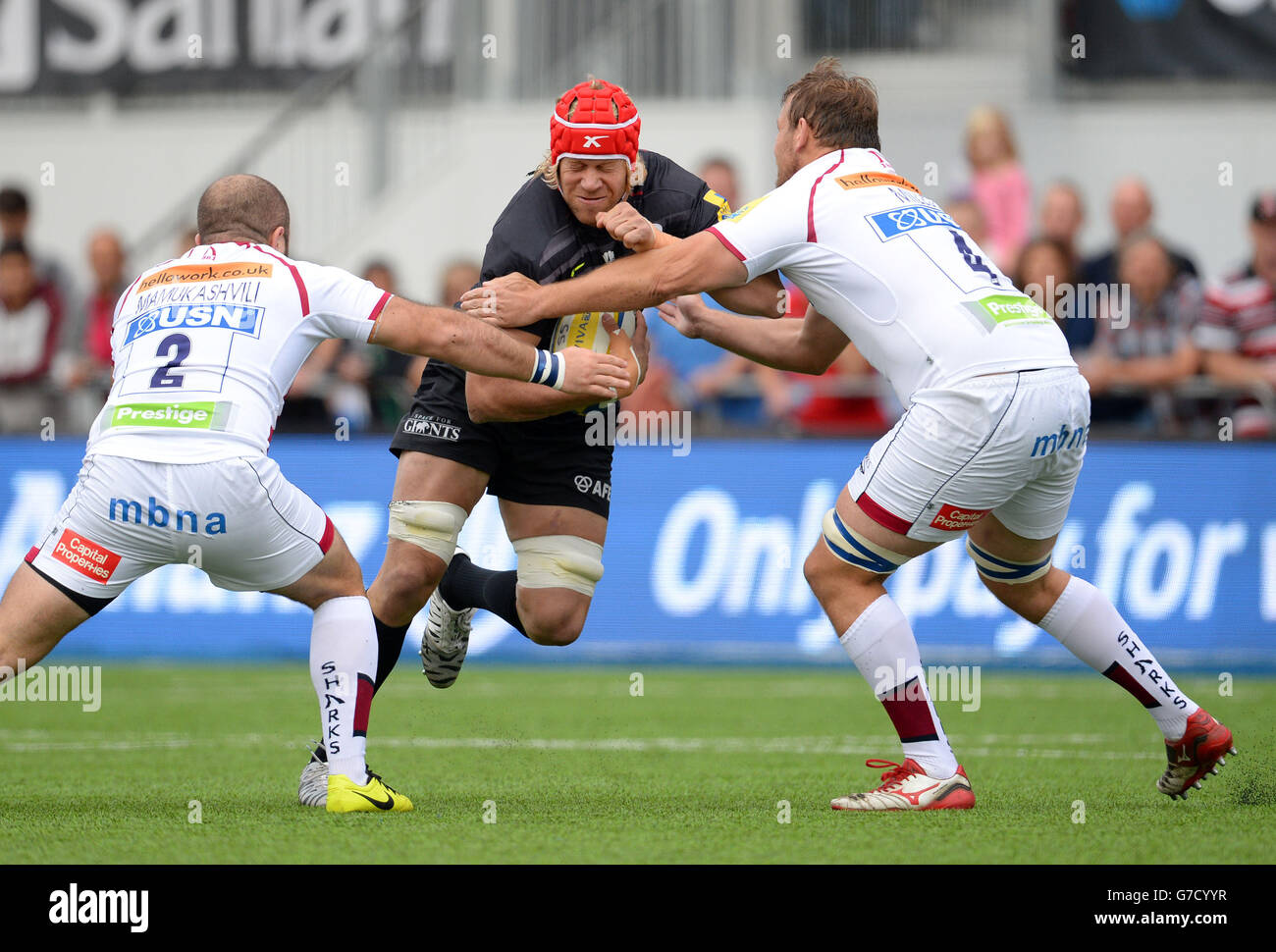 Saracens' Mouritz Botha (centre) is tackled by Sale Sharks' Shalva ...