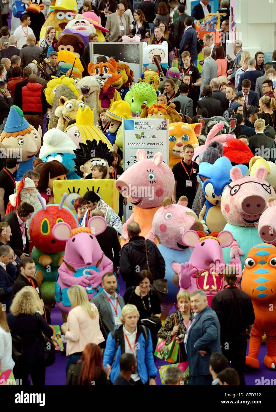 A large group of cartoon characters mingle with business visitors at ...