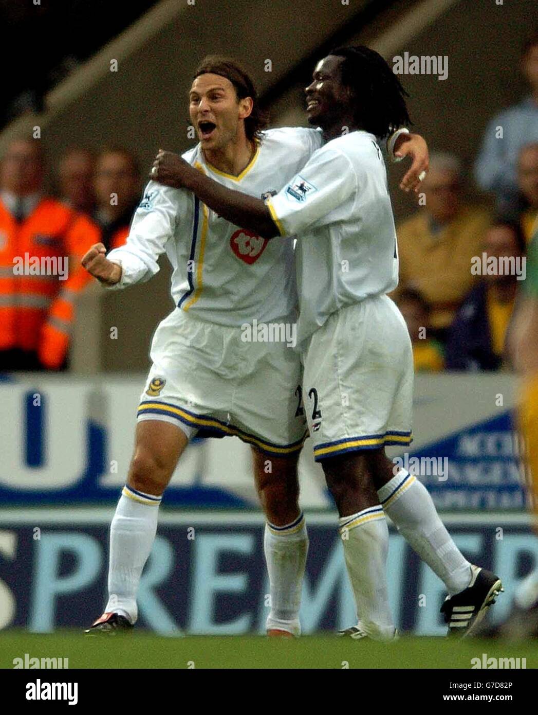 Portsmouth's Patrik Berger celebrates with Linvoy Primus (right) after ...