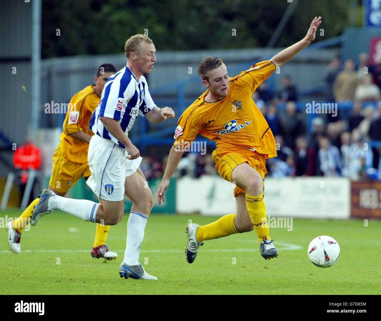 Colchester's Stephen Hunt in action against Port Vale's Chris Birchall ...