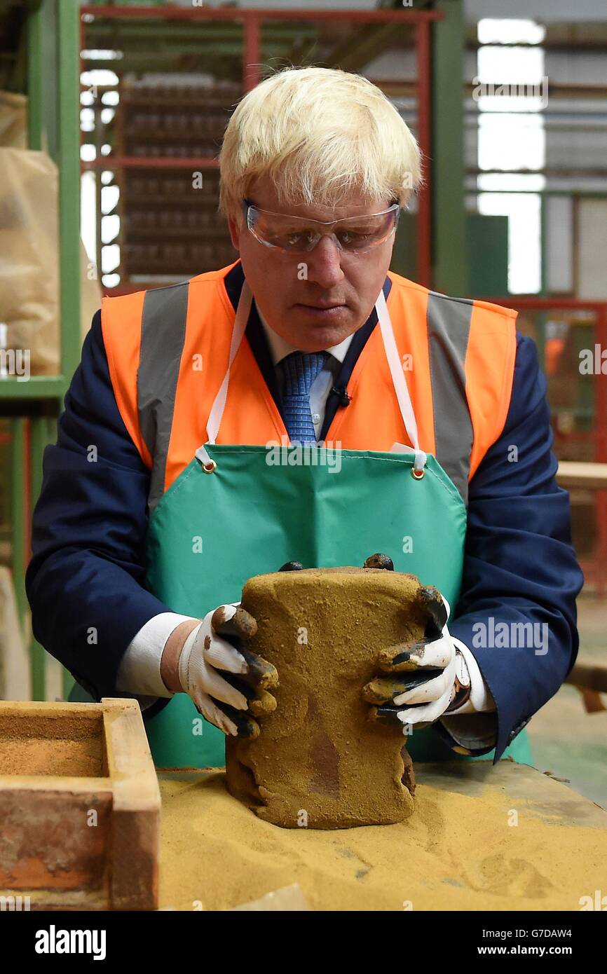 Mayor of London Boris Johnson makes his own brick during a visit to ...